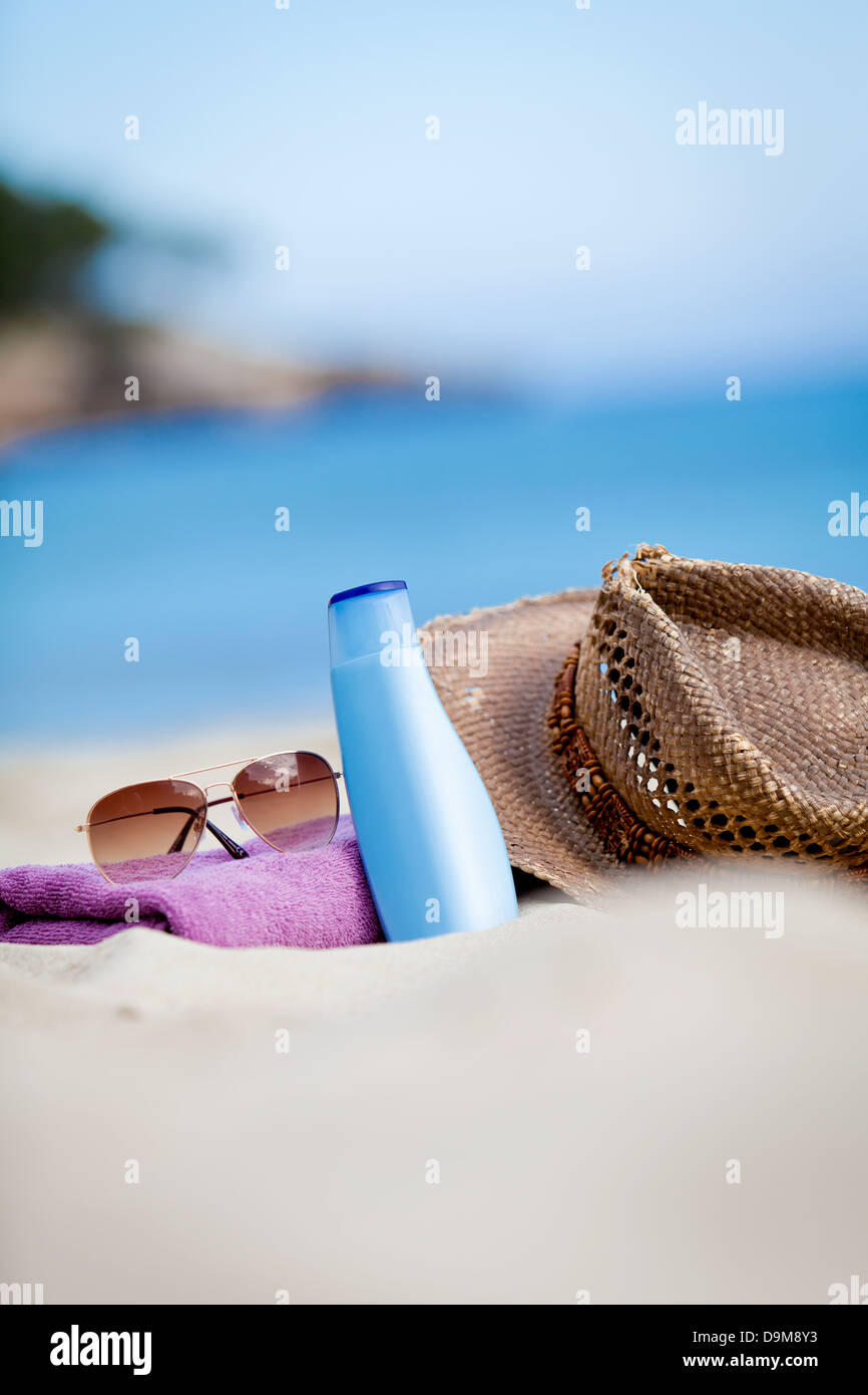sunprotection objects on the beach in holiday sunglasses hat suncare ...