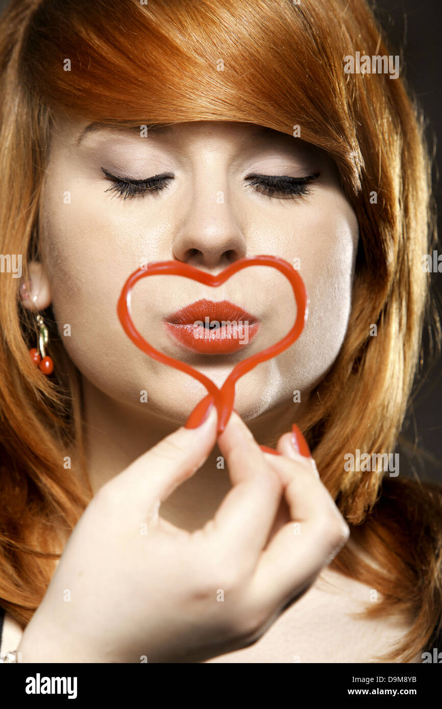 happy redhair young girl holding one little red heart love symbol ...
