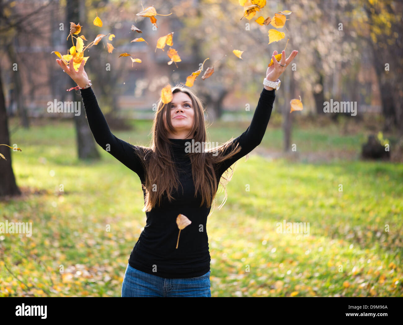 young woman throwing leaves woman in the forest Stock Photo - Alamy