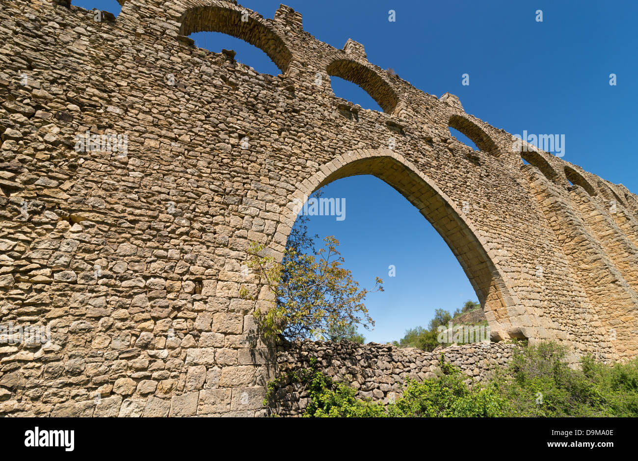 Main arch and remaining top arches of an ancient aqueduct Stock Photo ...