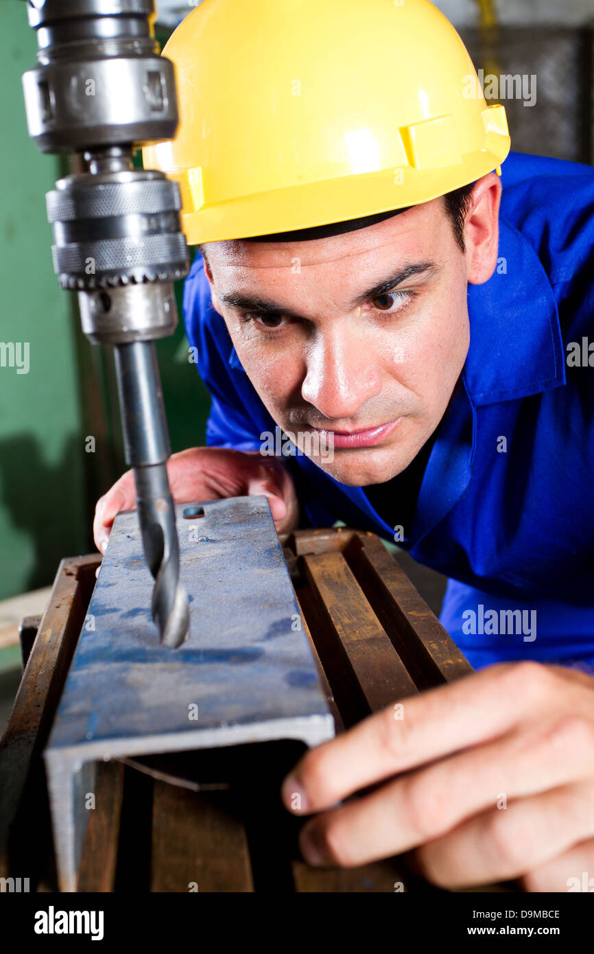 factory worker using industrial drilling machine Stock Photo - Alamy