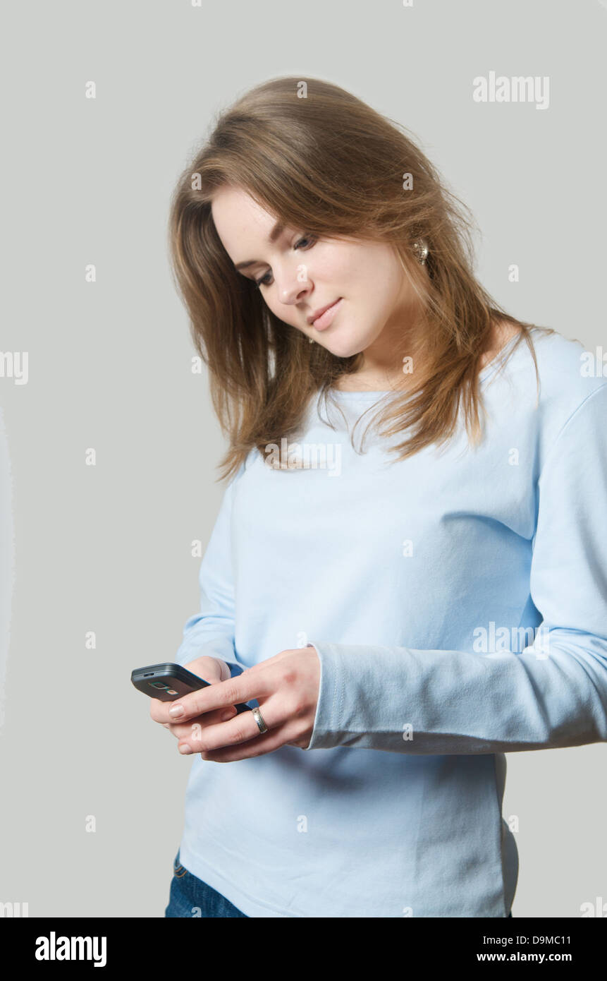 Girl dialing an phone in her hand Stock Photo - Alamy