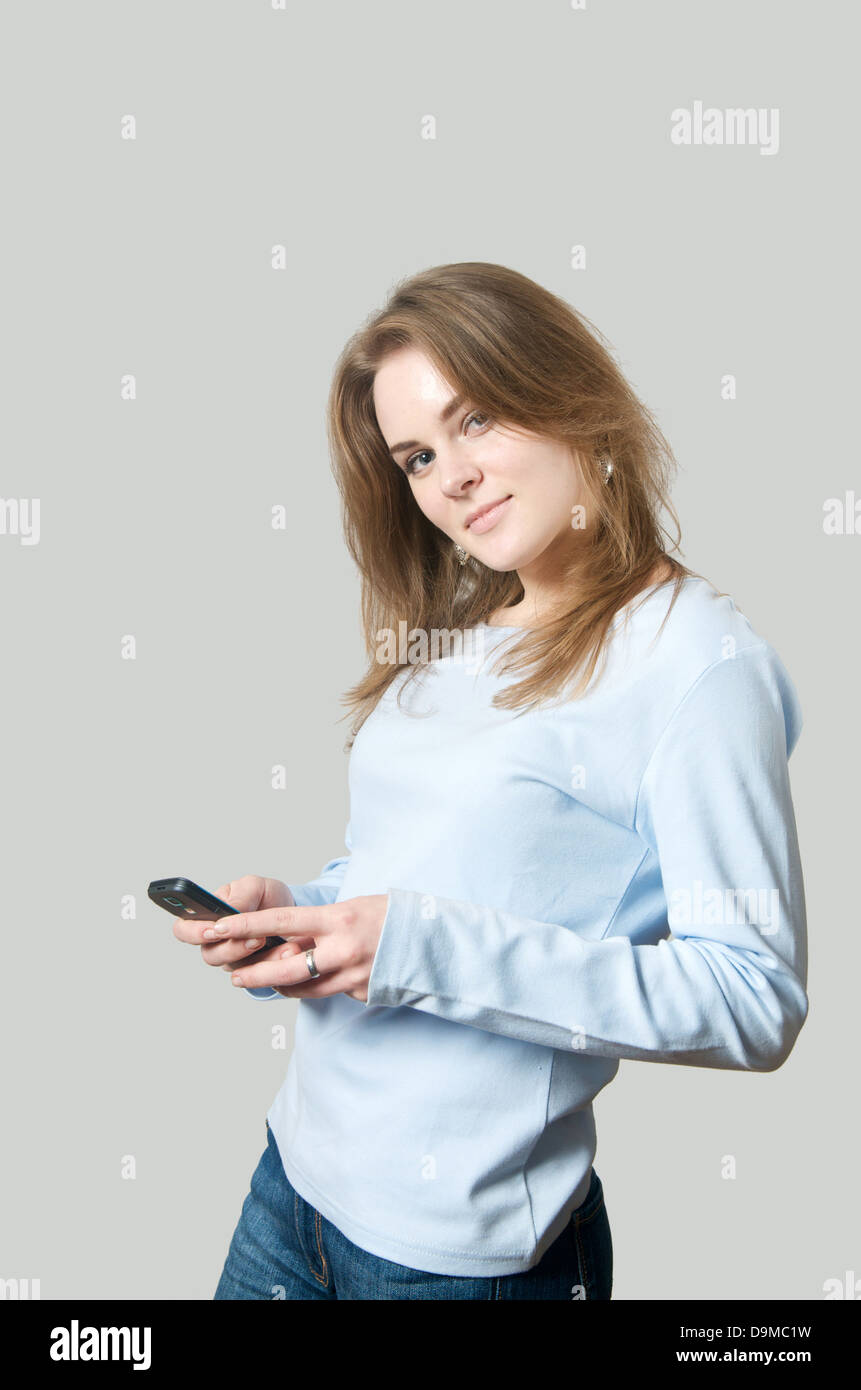 Girl dialing an phone in her hand Stock Photo - Alamy