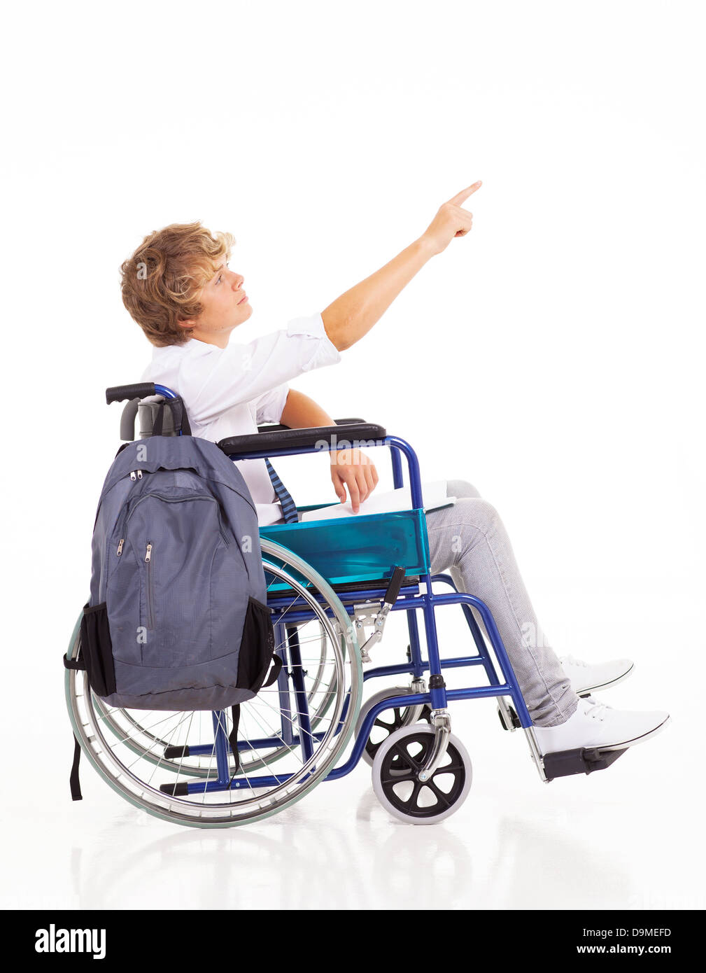 disabled teen boy sitting on wheelchair and pointing on white ...