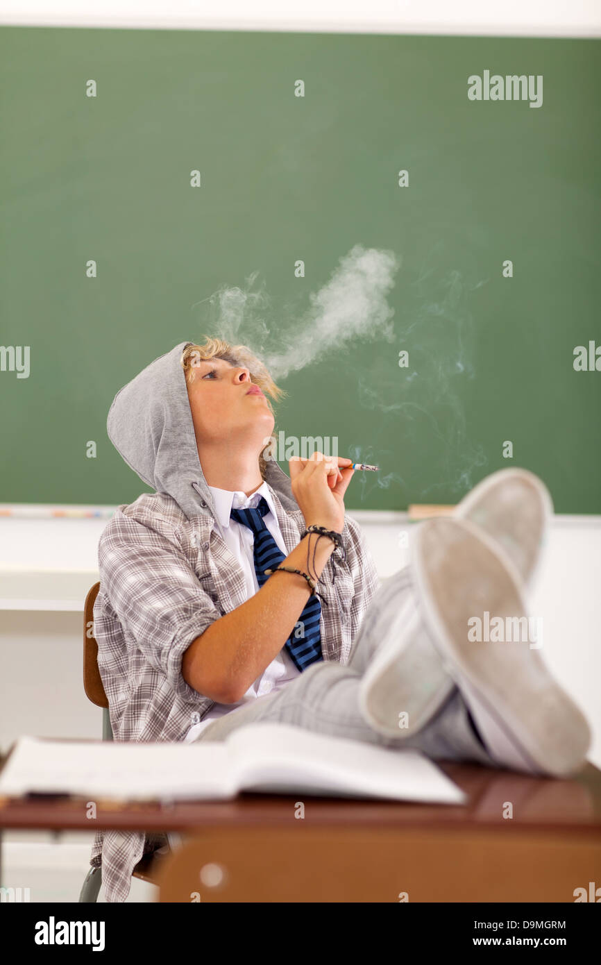 troublesome teen boy smoking in classroom Stock Photo - Alamy