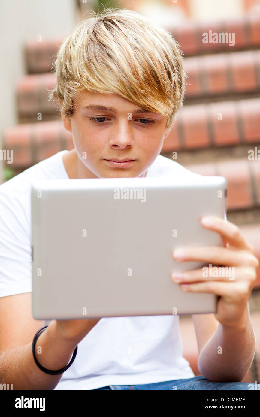 teen boy using tablet computer outdoors Stock Photo - Alamy