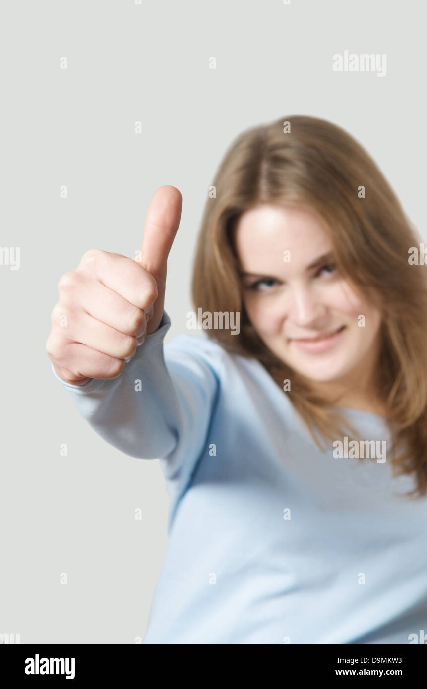 Beautiful girl with Thumbs up hand Stock Photo - Alamy