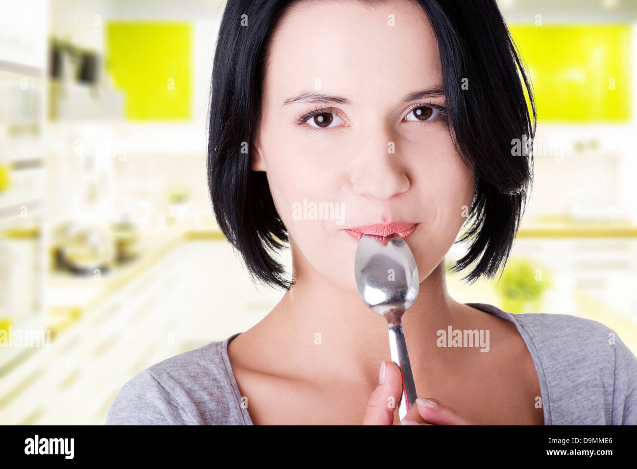 Young smiling woman with spoon (pleasure from eating Stock Photo - Alamy