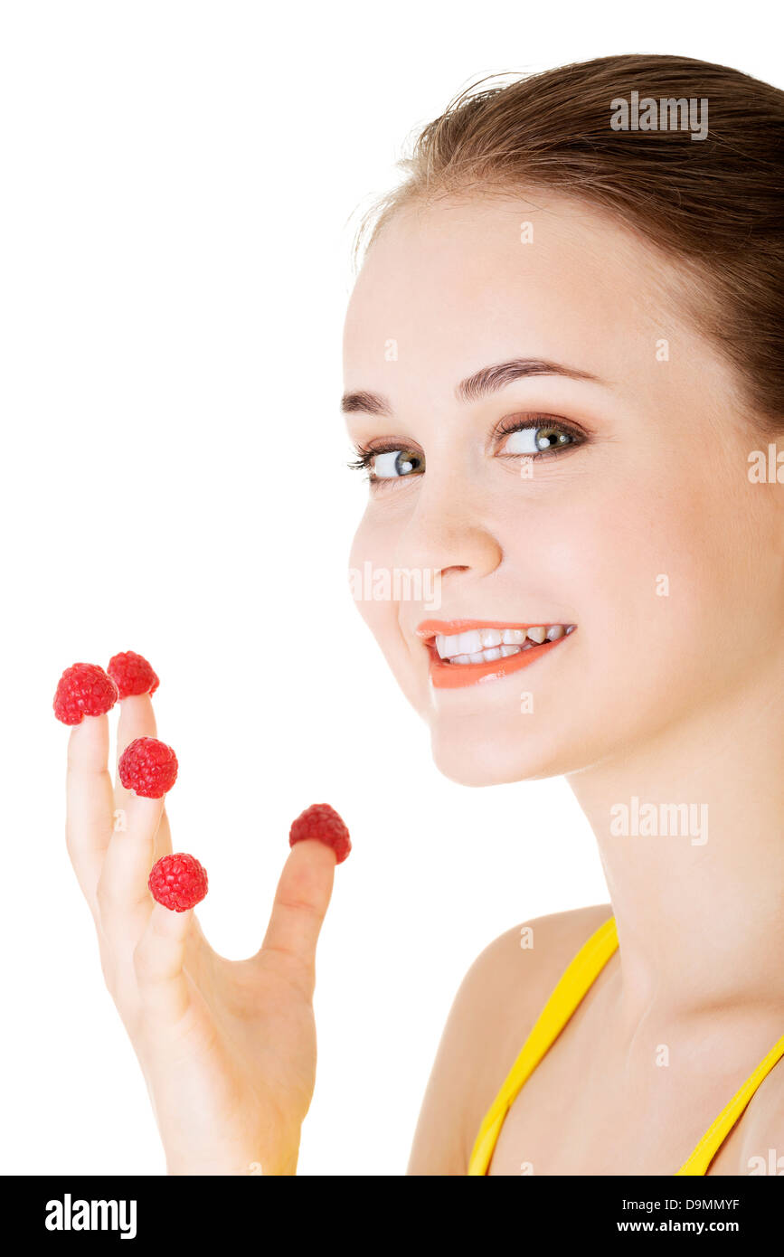 Smiling casual woman with raspberries, isolated on white Stock Photo ...