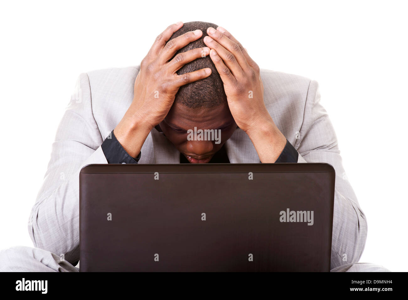 Stressed businessman working on laptop, isolated on white Stock Photo ...