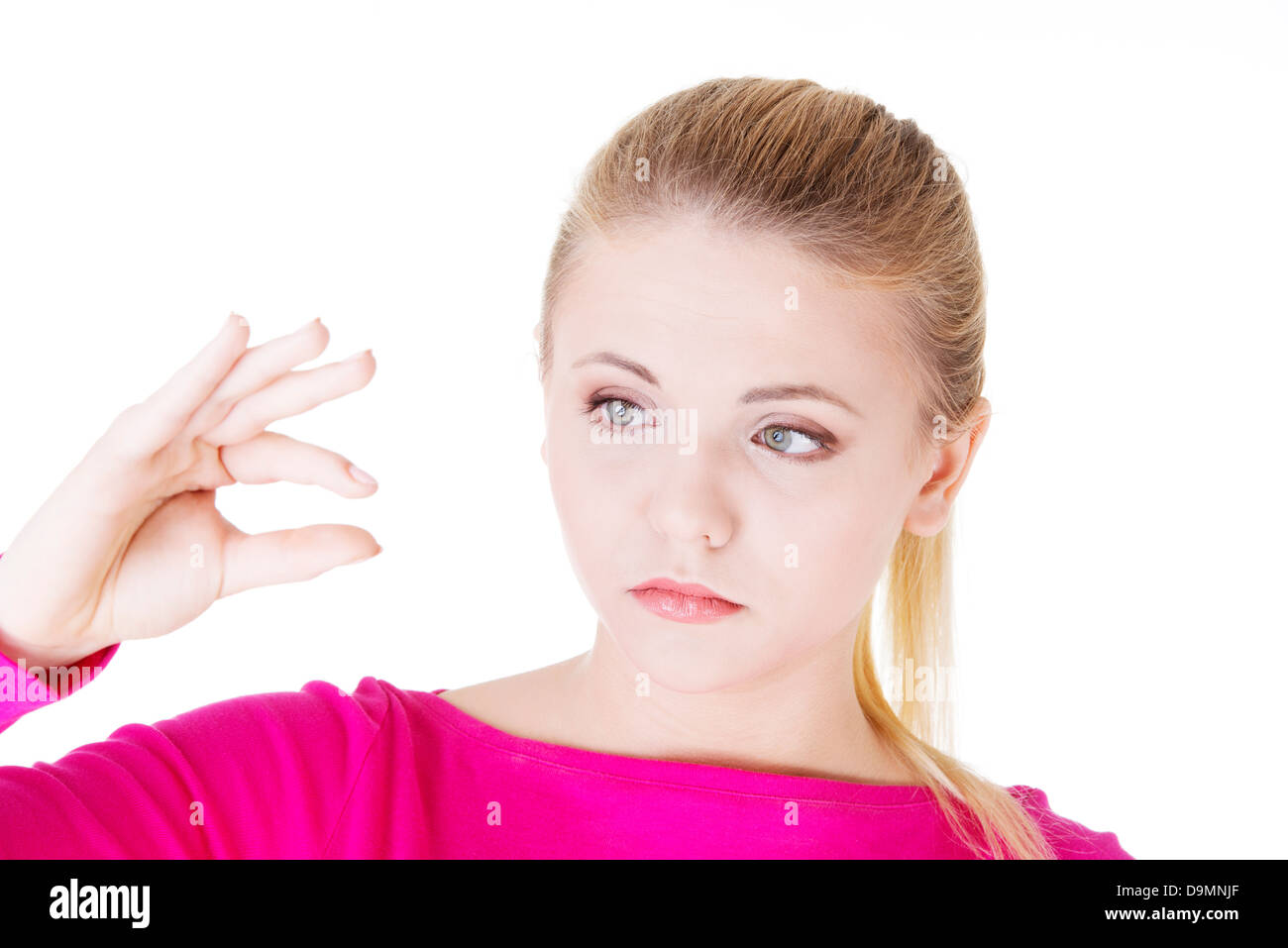 Woman showing something small, isolated on white Stock Photo - Alamy