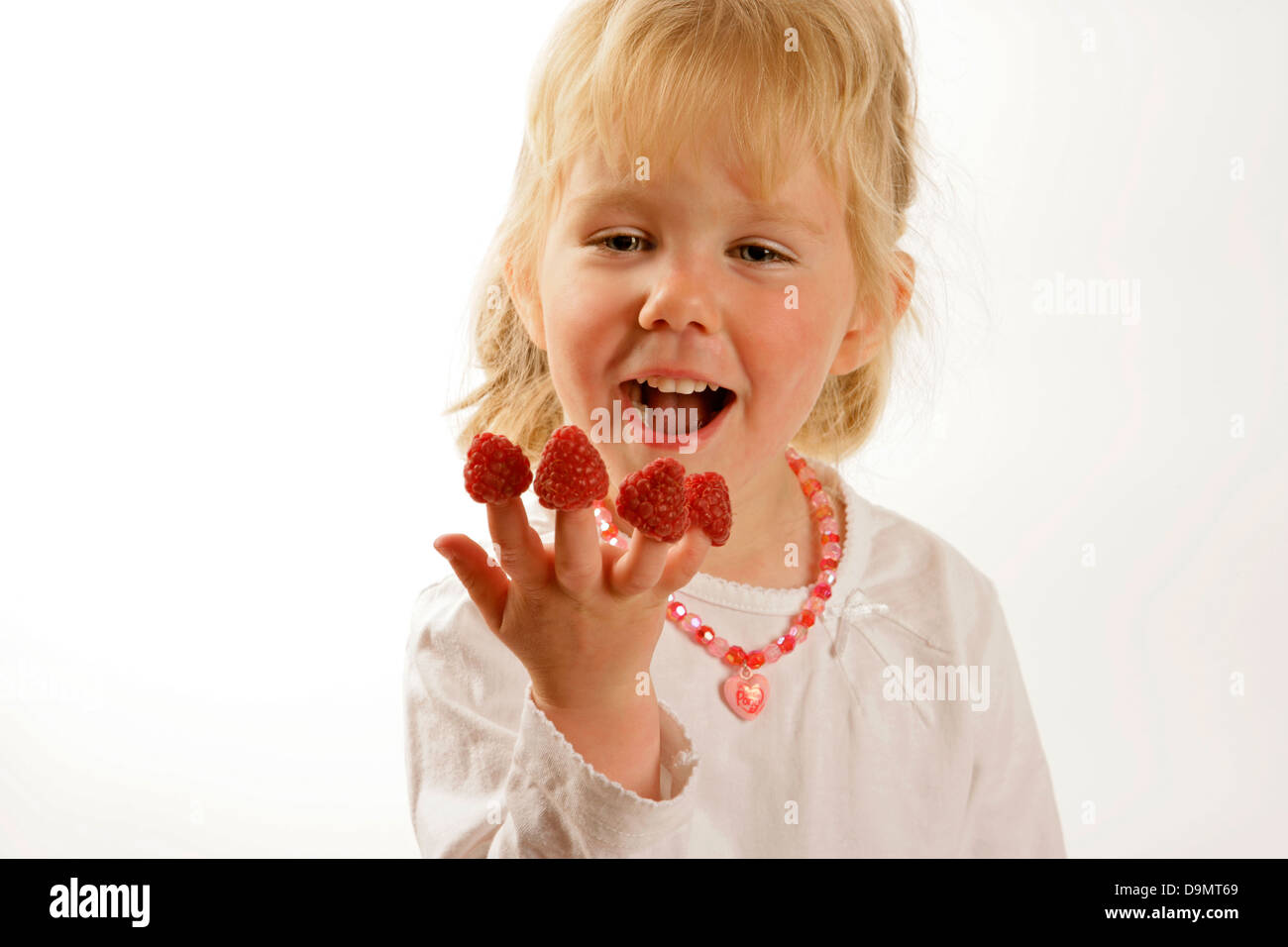 child with raspberries on her fingers Stock Photo - Alamy