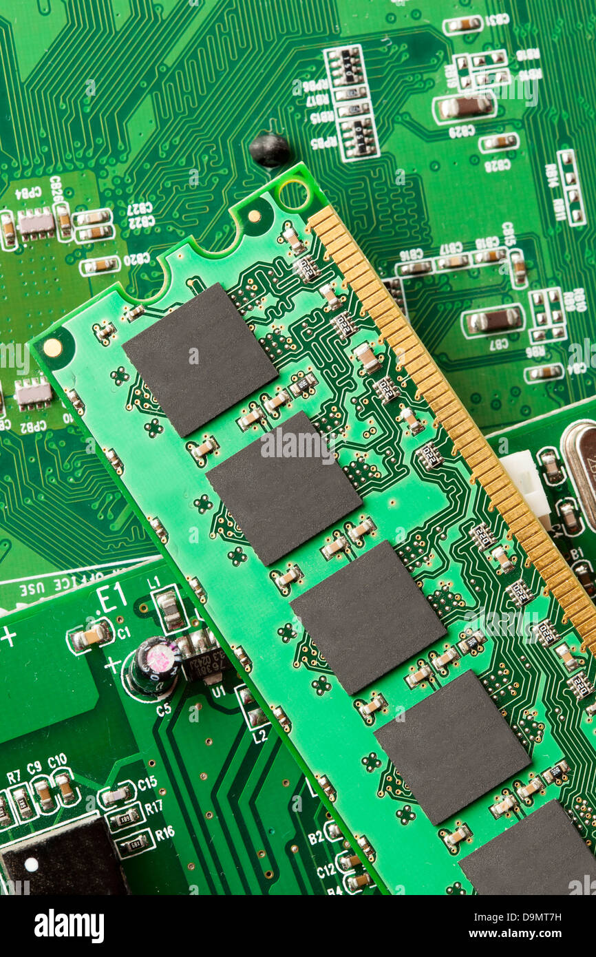 Green Electrical Circuit Board with microchips, conductors, and ...