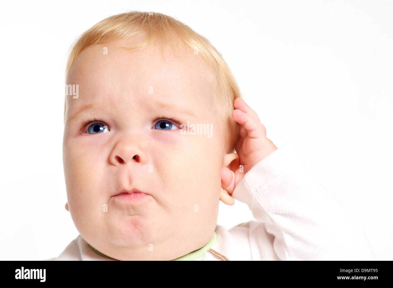 Confused blond baby with blue eyes portrait Stock Photo - Alamy