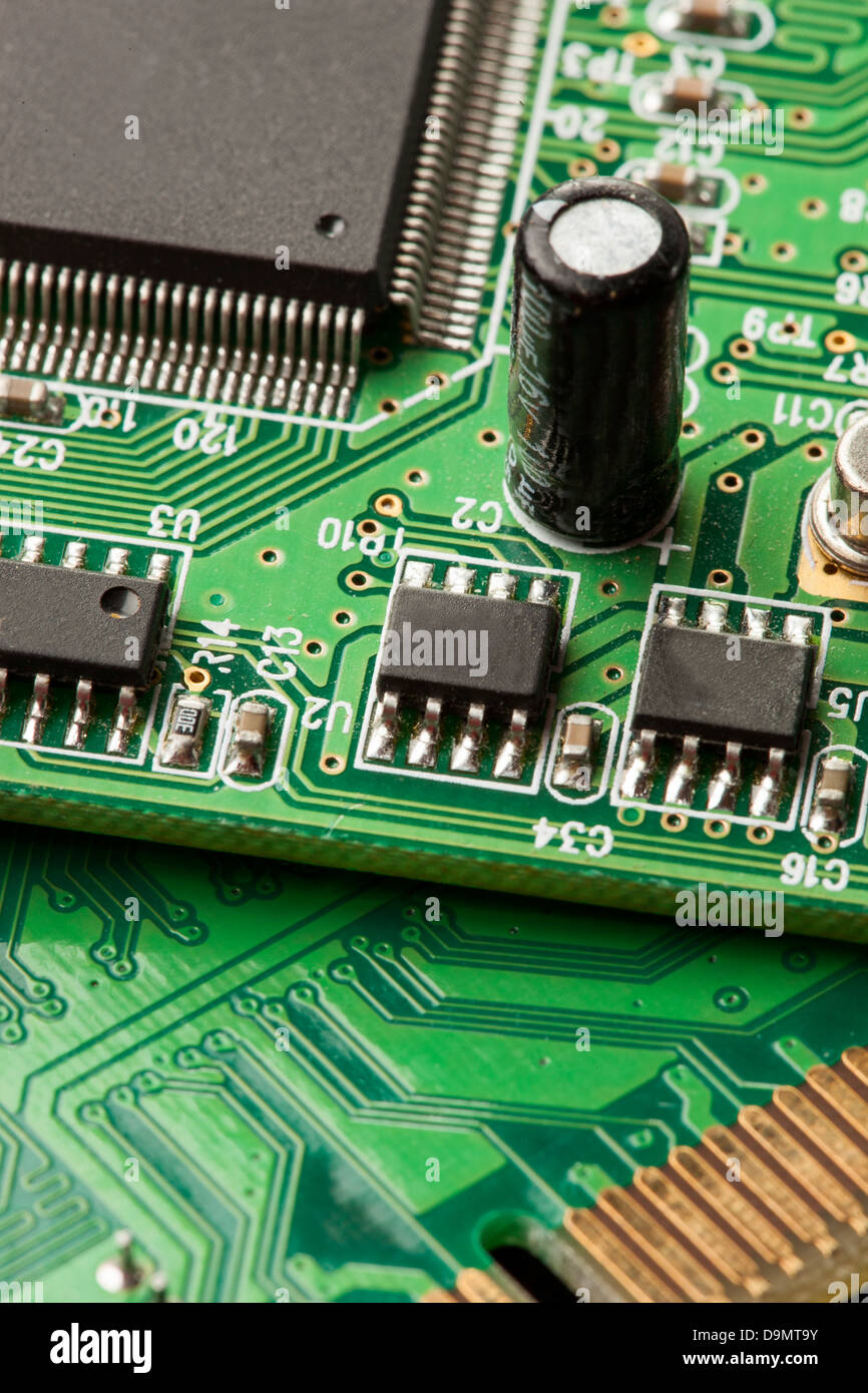 Green Electrical Circuit Board with microchips, conductors, and ...