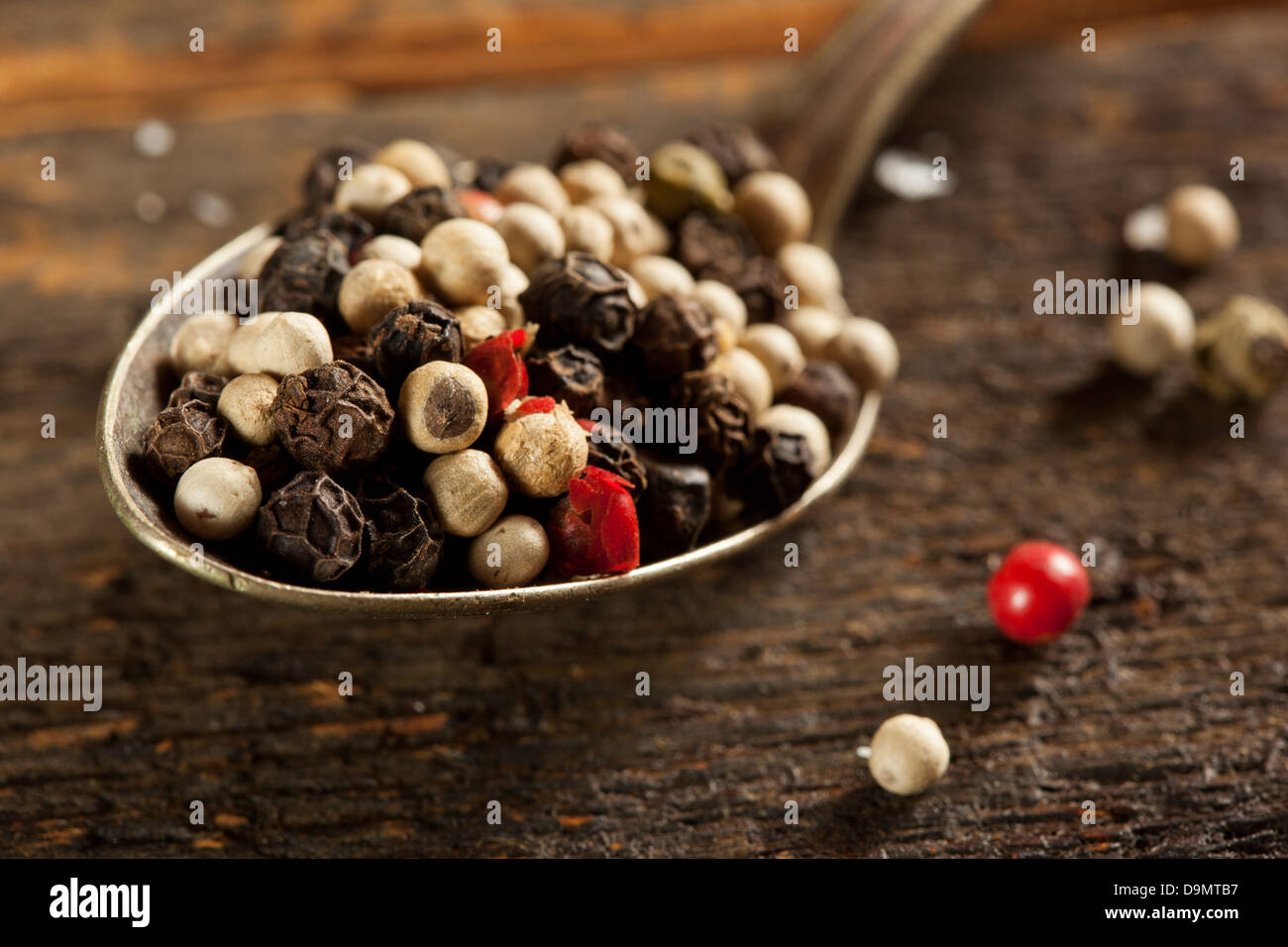 Raw Organic Hot Peppercorn Pepper against a background Stock Photo - Alamy