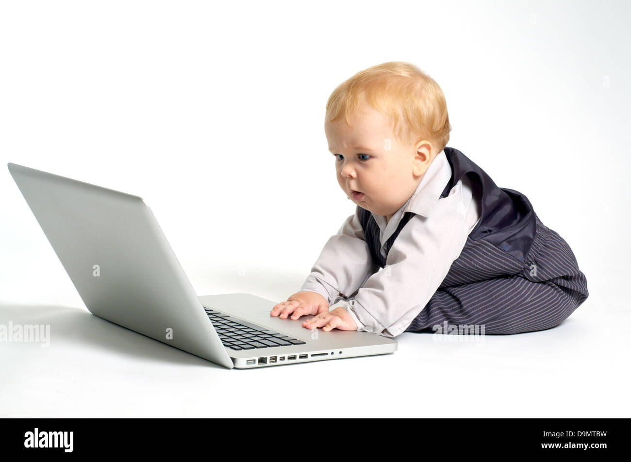 blond baby in suit working with laptop Stock Photo - Alamy