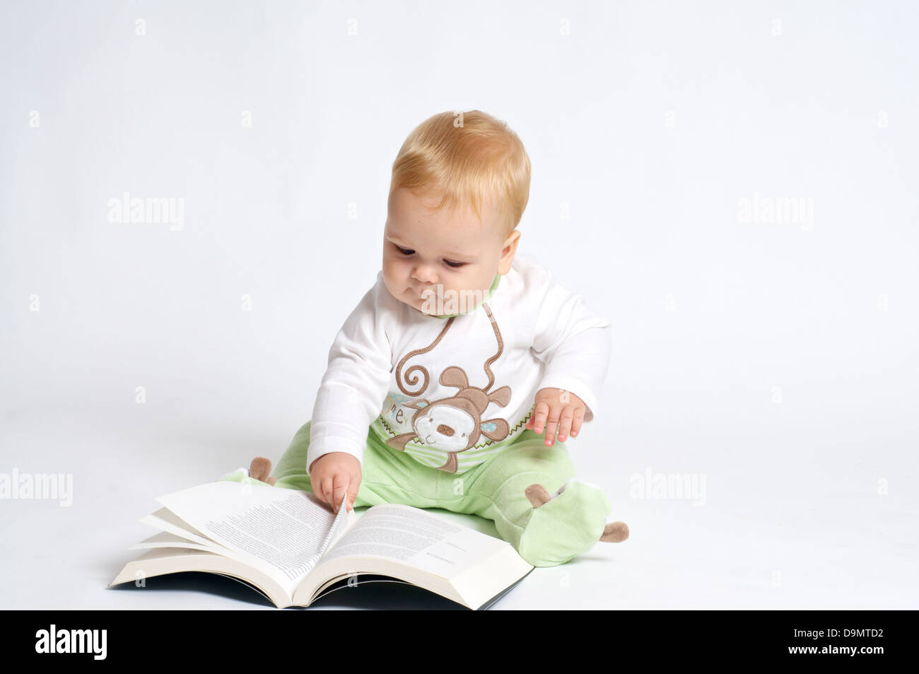 smart blond baby sitting and reading a book Stock Photo - Alamy