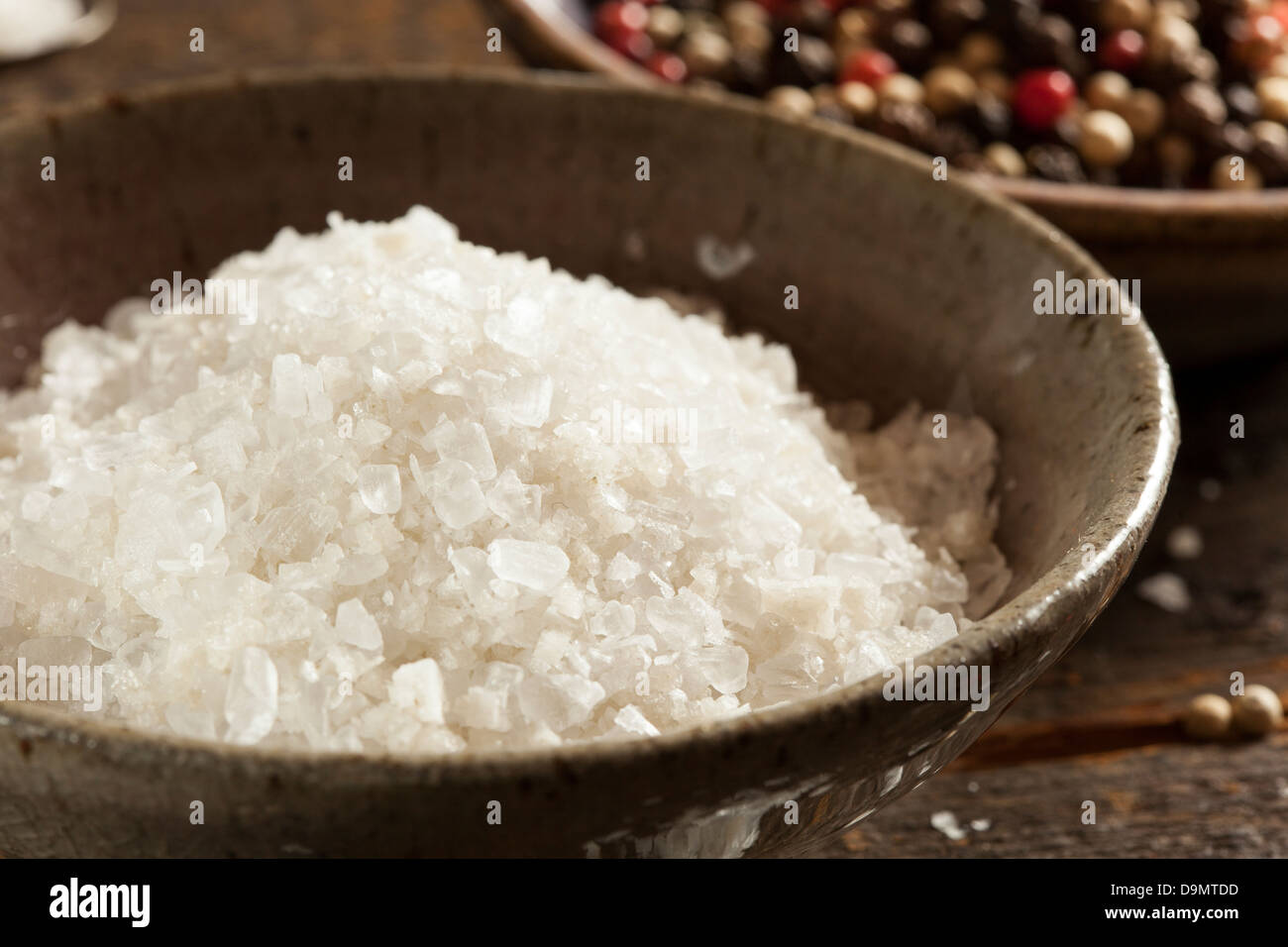 Raw Organic Sea Salt and Pepper against a background Stock Photo - Alamy