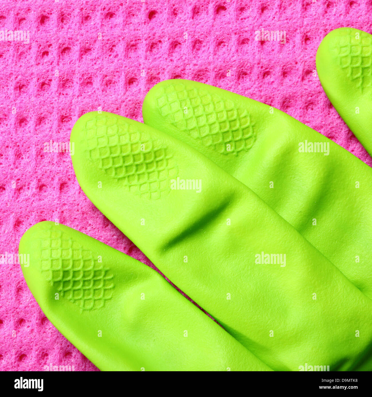 Close up pink kitchen sponge and green rubber glove Stock Photo - Alamy