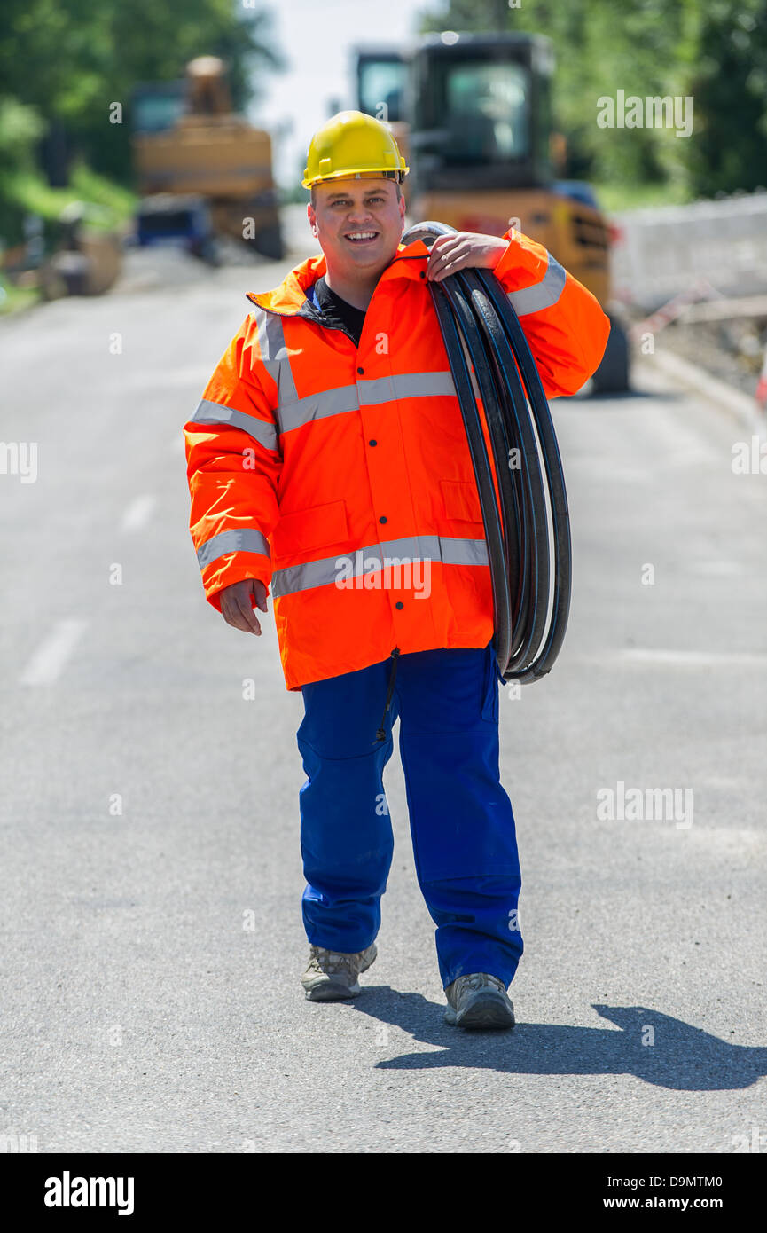 Model released, Construction worker with a water hose Stock Photo - Alamy