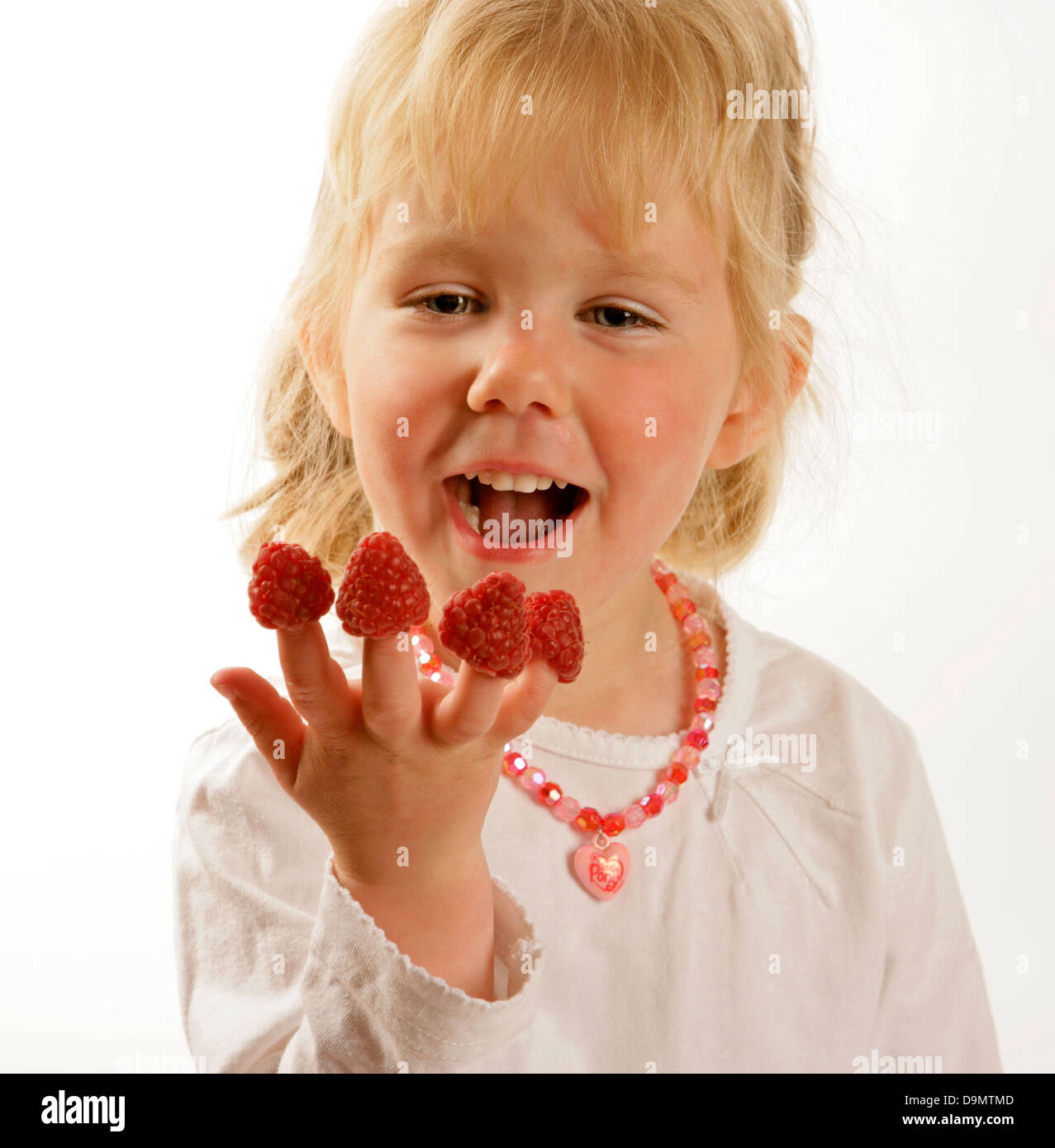 child with raspberries on her fingers Stock Photo - Alamy