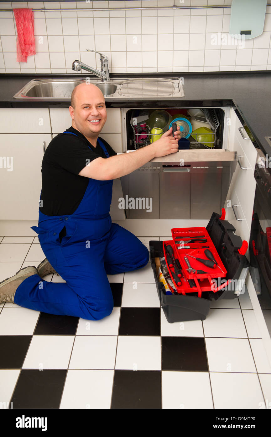 Engineer repairs a washer (model release Stock Photo - Alamy