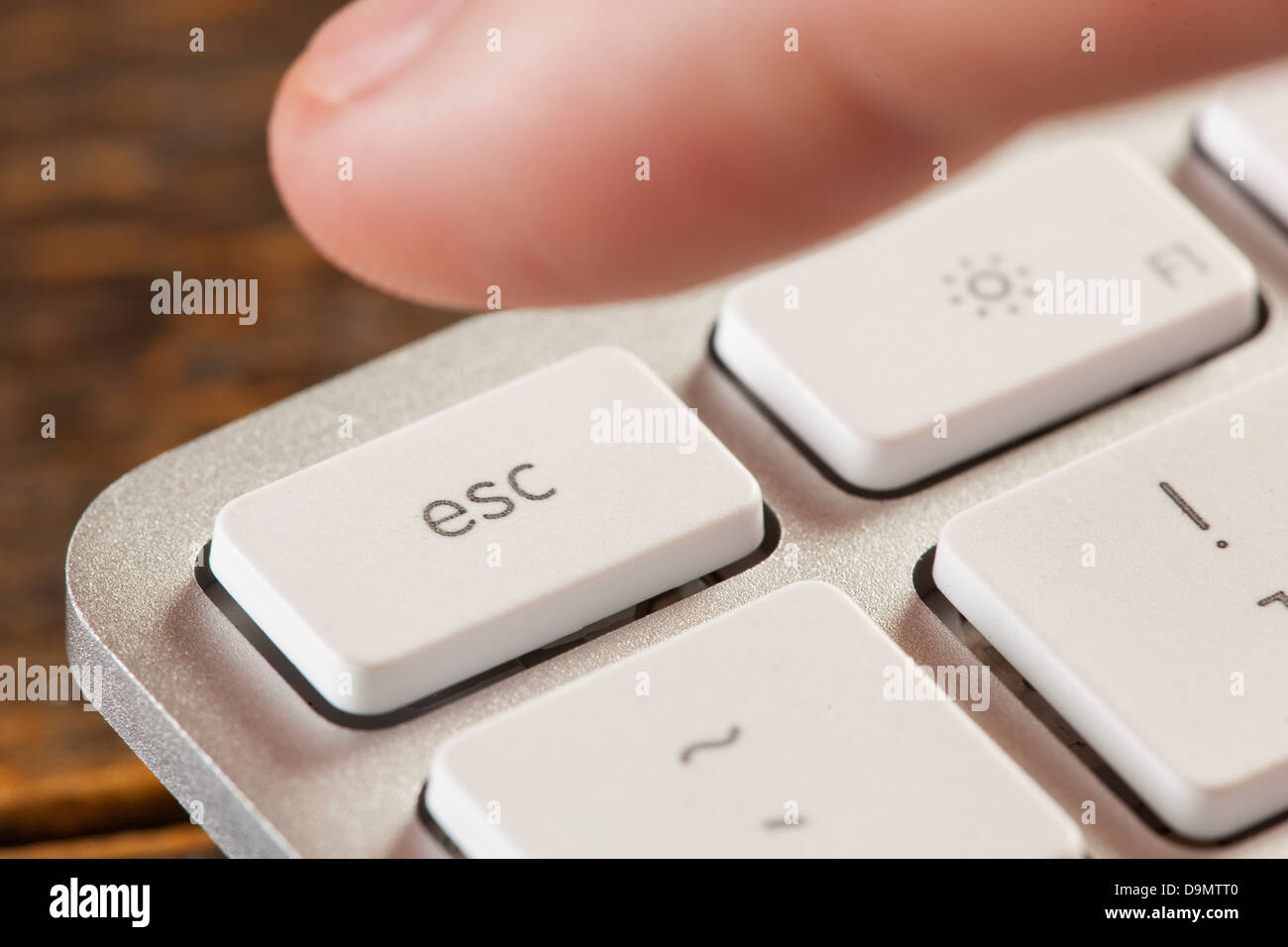 Finger Pressing Escape on a white and Grey Computer Keyboard Stock ...