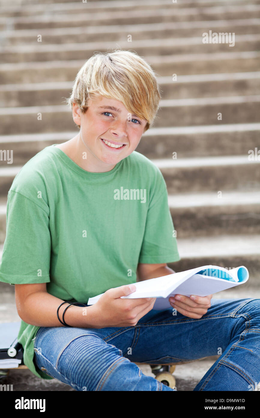 happy teen boy reading book Stock Photo - Alamy