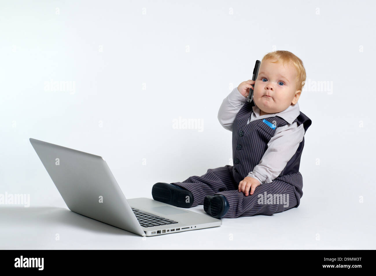 blond baby in suit working with laptop Stock Photo - Alamy
