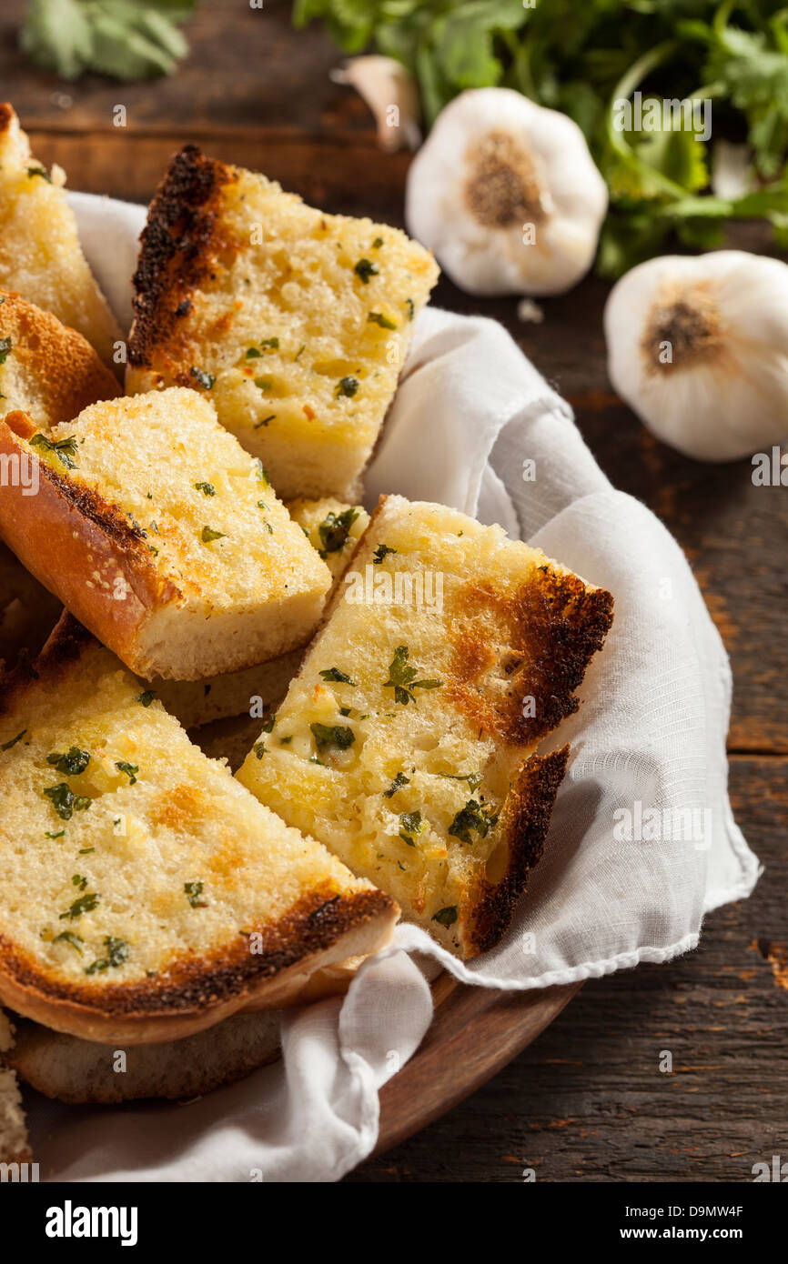 Homemade Crunchy Garlic Bread with butter and parsley Stock Photo - Alamy