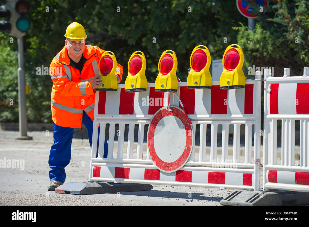 (Model release) Worker checks the building site roadblock Stock Photo ...