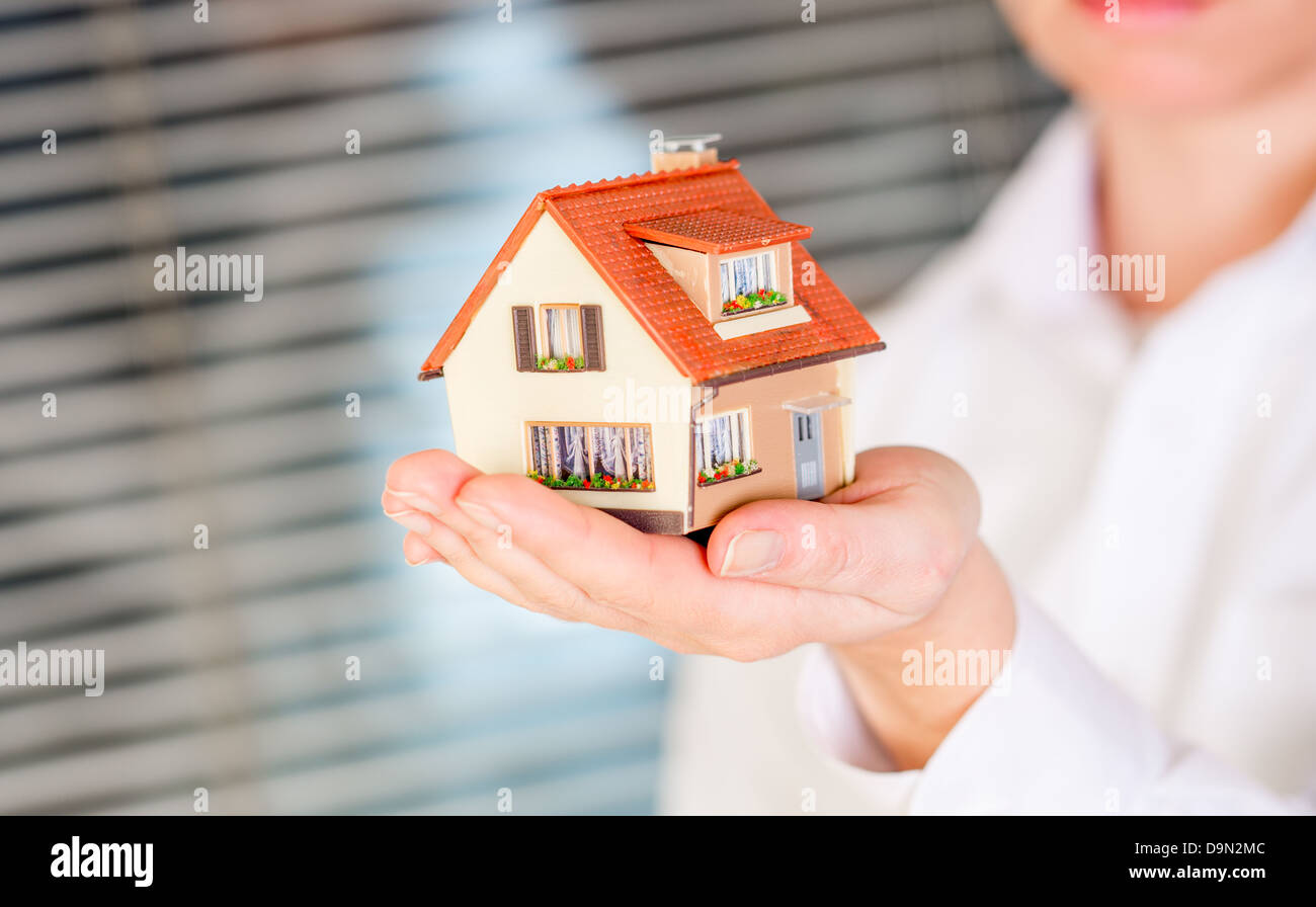 house in human hands on a white background Stock Photo - Alamy