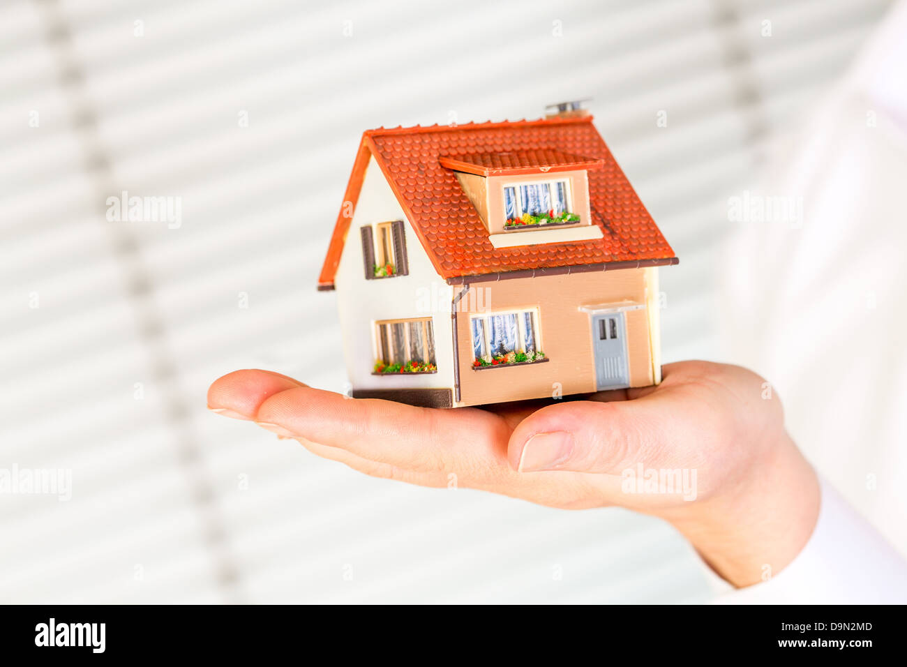 house in human hands on a white background Stock Photo - Alamy