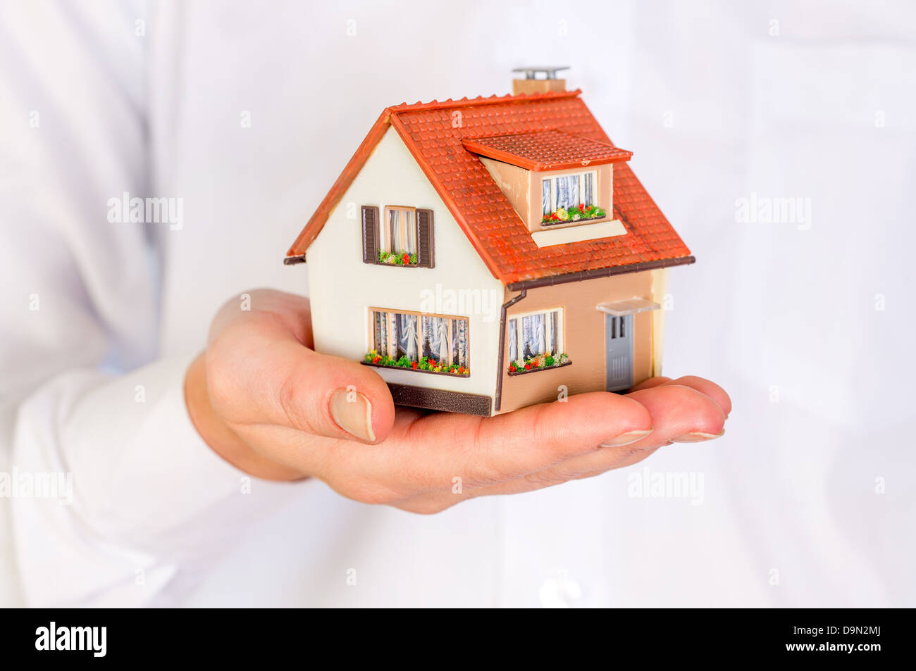 house in human hands on a white background Stock Photo - Alamy