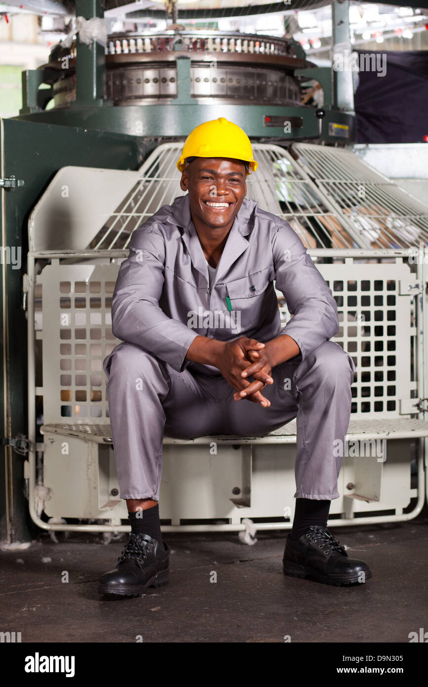 happy African American textile worker sitting on machine Stock Photo ...