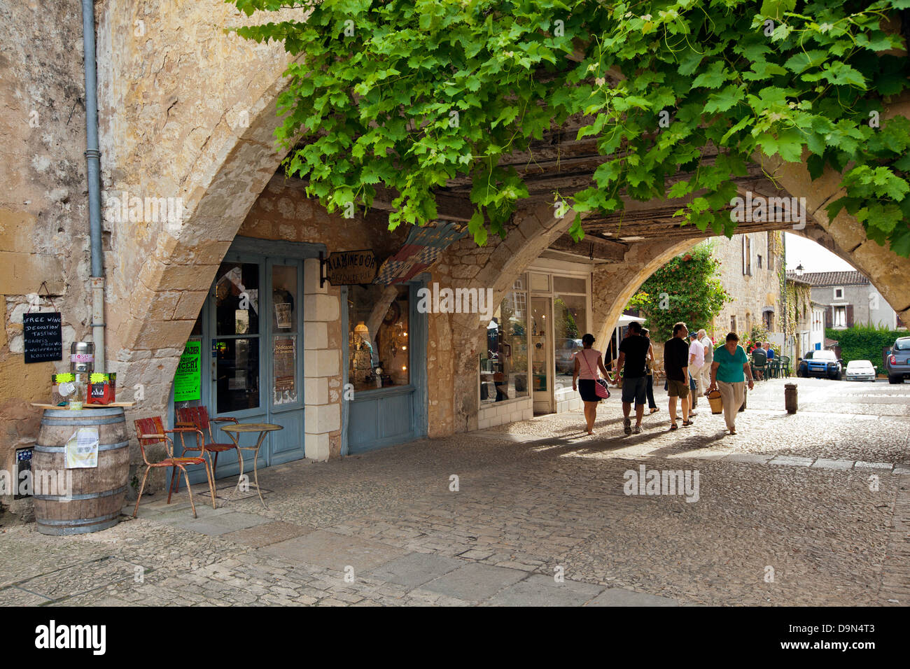 One of the many arches with shops and cafes around the Place des ...