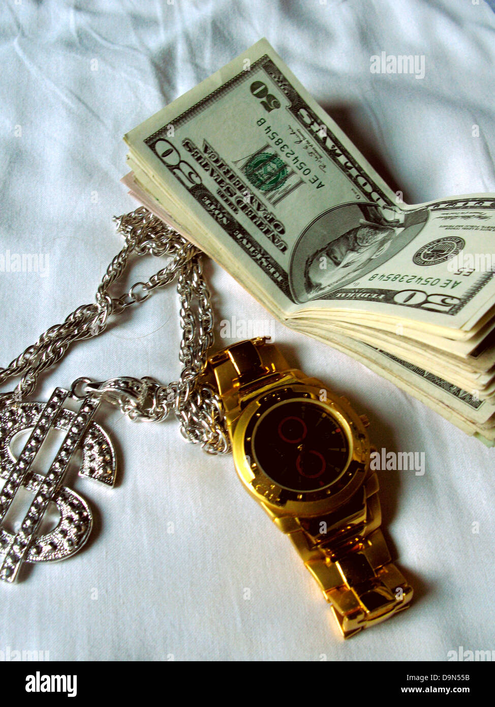 dollars and gold watch,symbols of wealth Stock Photo - Alamy