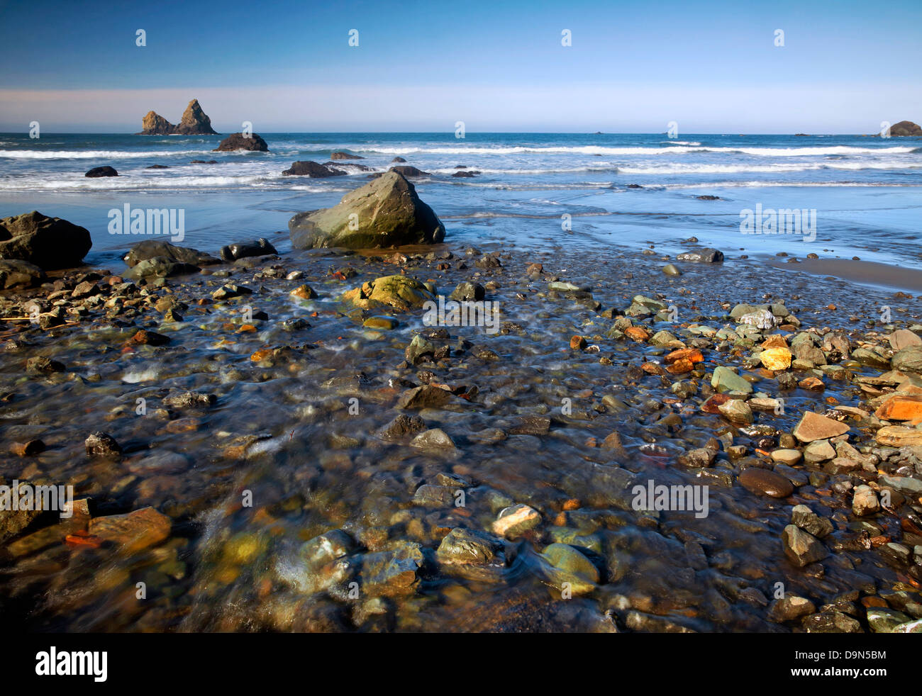Small creek crossing the sand at Lone Ranch Beach on the edge of the ...