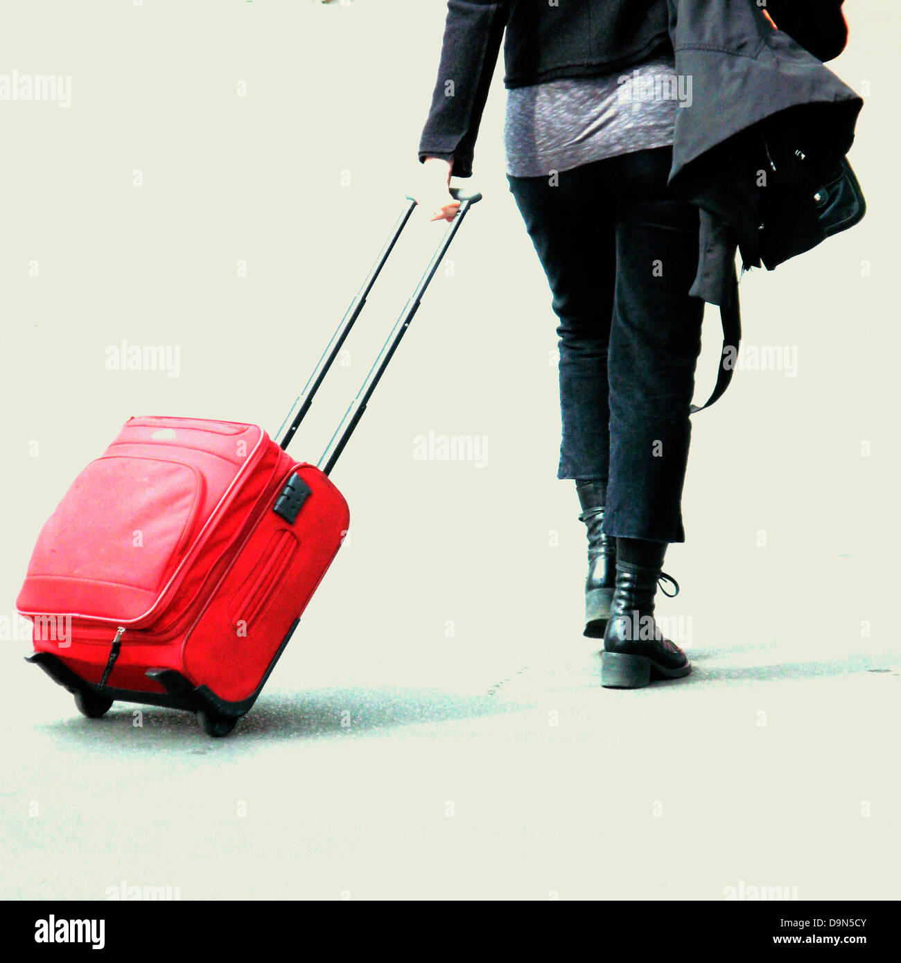 woman walking with rolling suitcase Stock Photo - Alamy