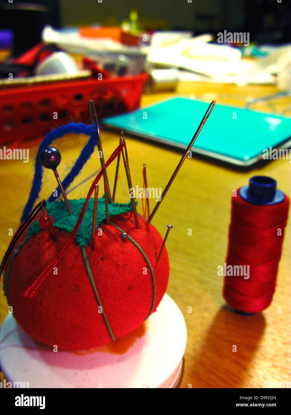 a tailor's table with needles and pins Stock Photo - Alamy