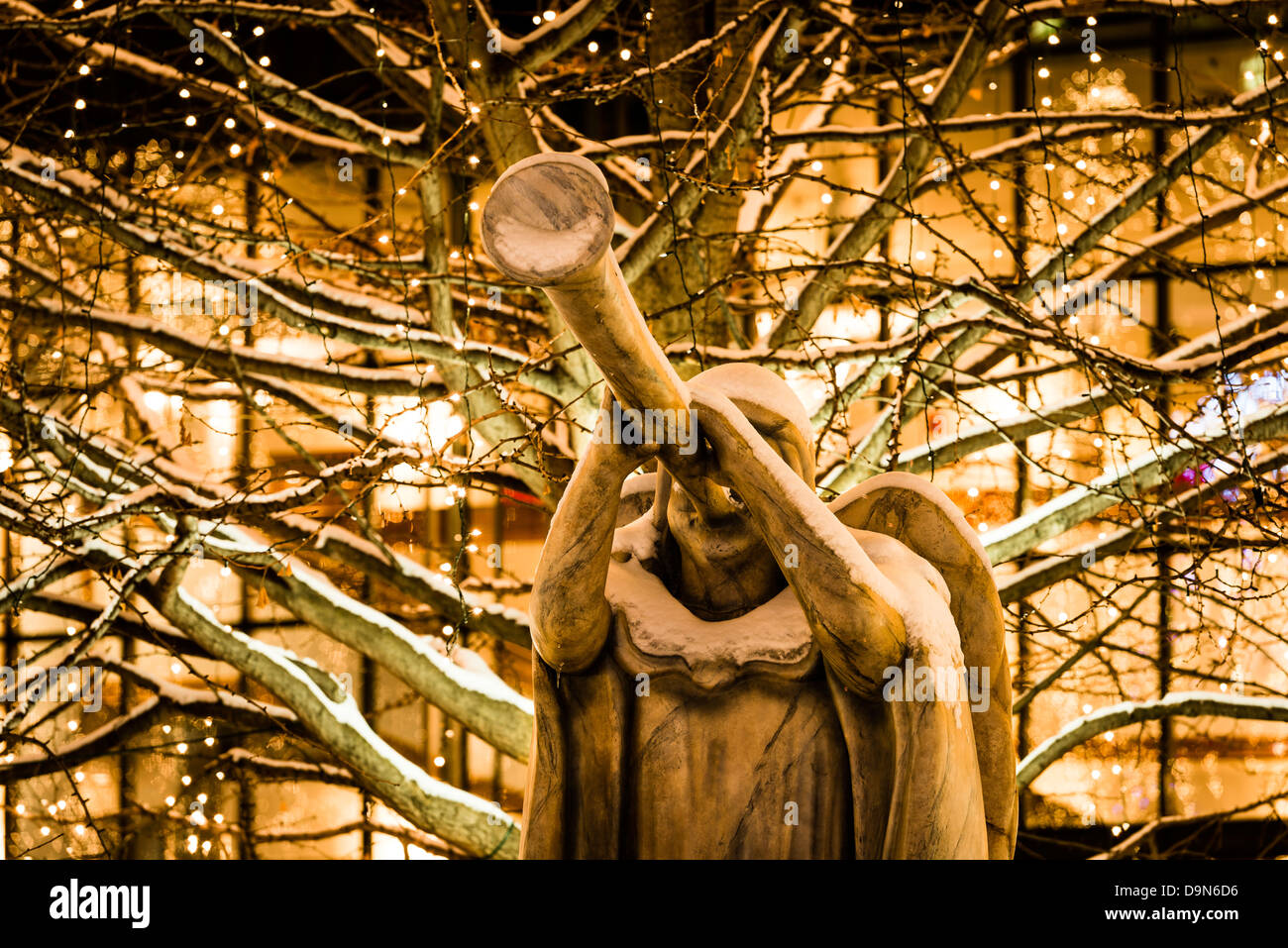 A statue of an angel with horn welcomes the holiday season in Rice Park ...
