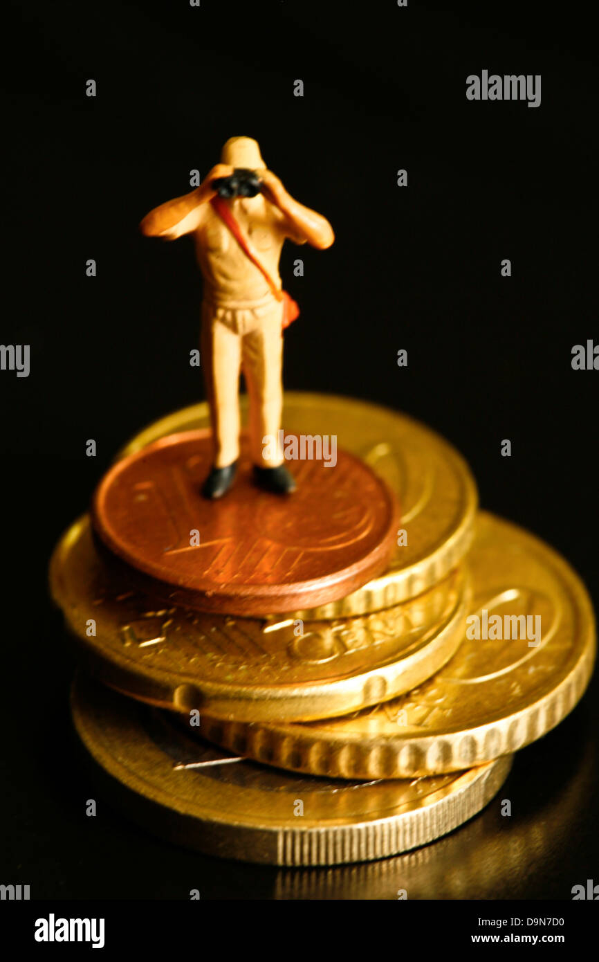 man on euro coin piles Stock Photo - Alamy