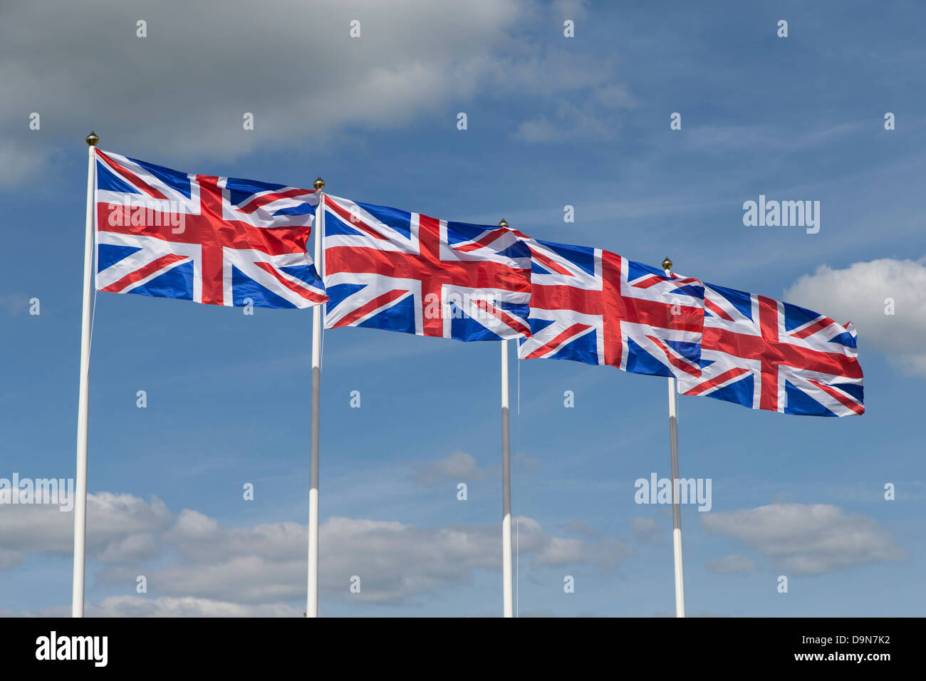 Four Union Jack Flags on Flagpoles Stock Photo - Alamy