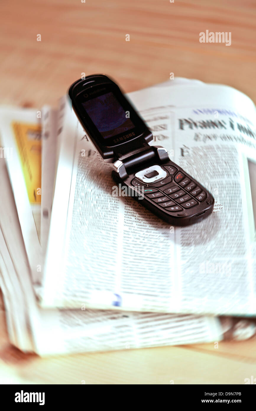 mobile phone on newspaper Stock Photo - Alamy