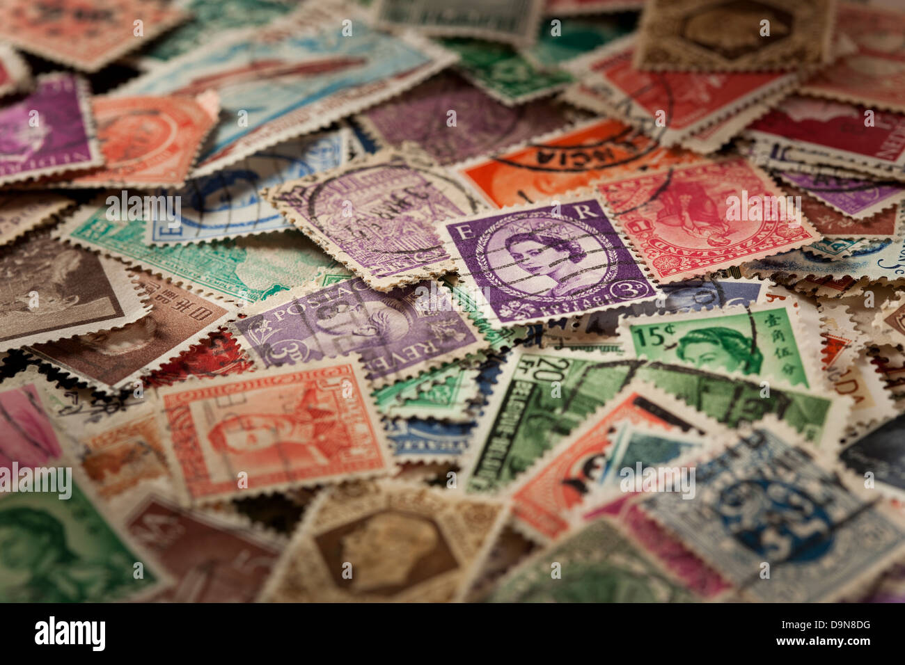 Colorful Vintage Used Postage Stamps in a pile Stock Photo - Alamy