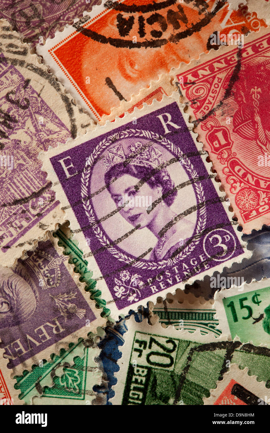 Colorful Vintage Used Postage Stamps in a pile Stock Photo - Alamy