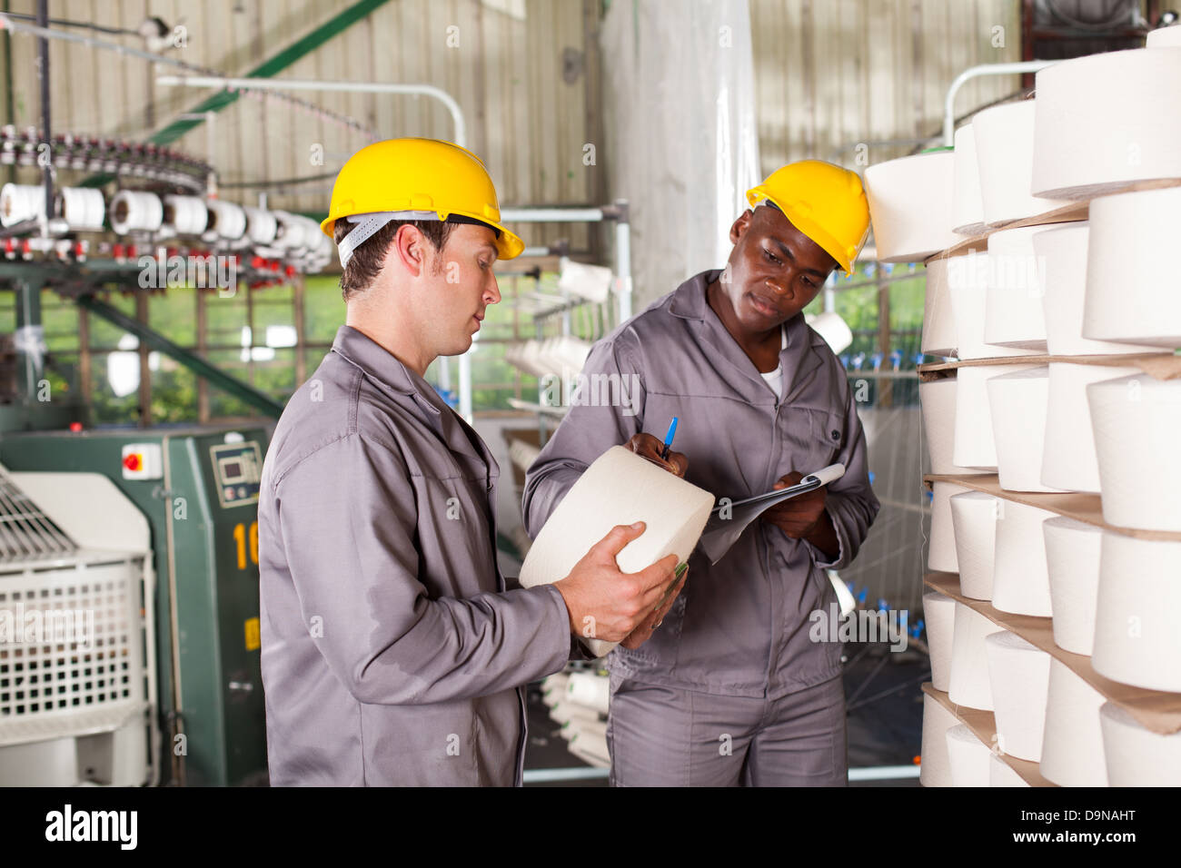 two textile workers checking raw material yarn Stock Photo - Alamy