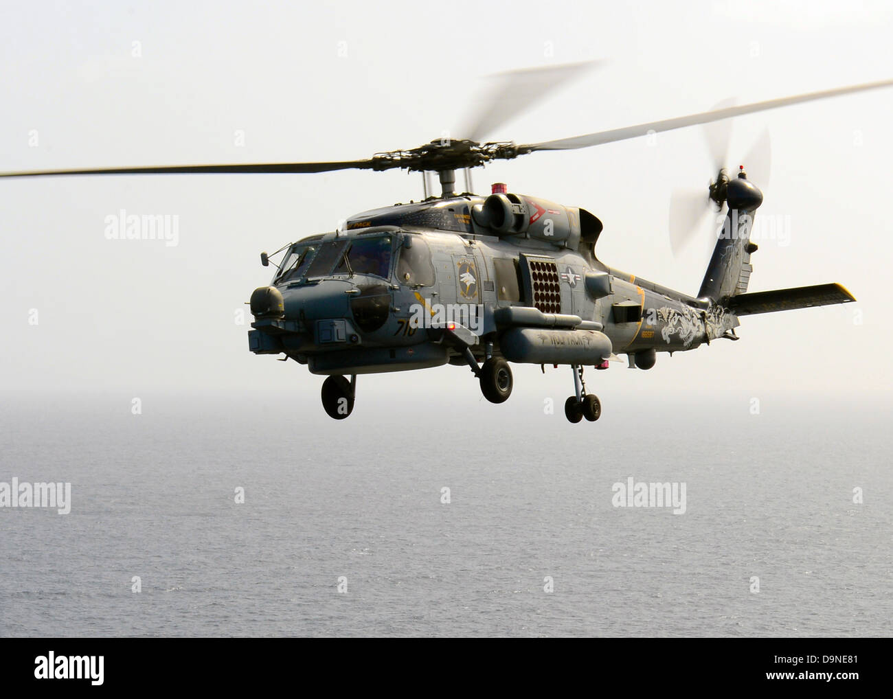 US Navy MH-60R Sea Hawk helicopters fly operating from the aircraft ...