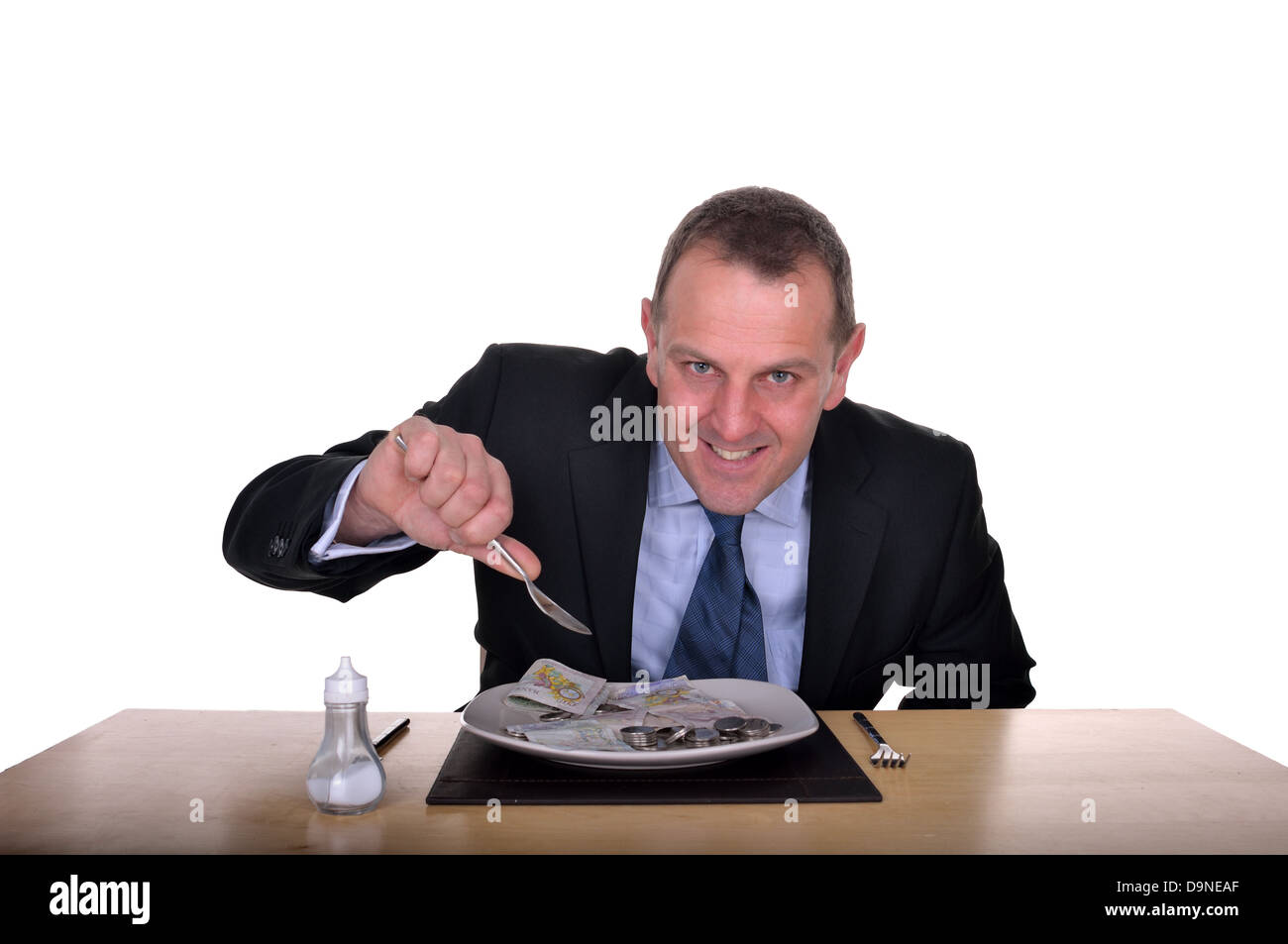 image of a happy businessman eating a plate full of money Stock Photo ...
